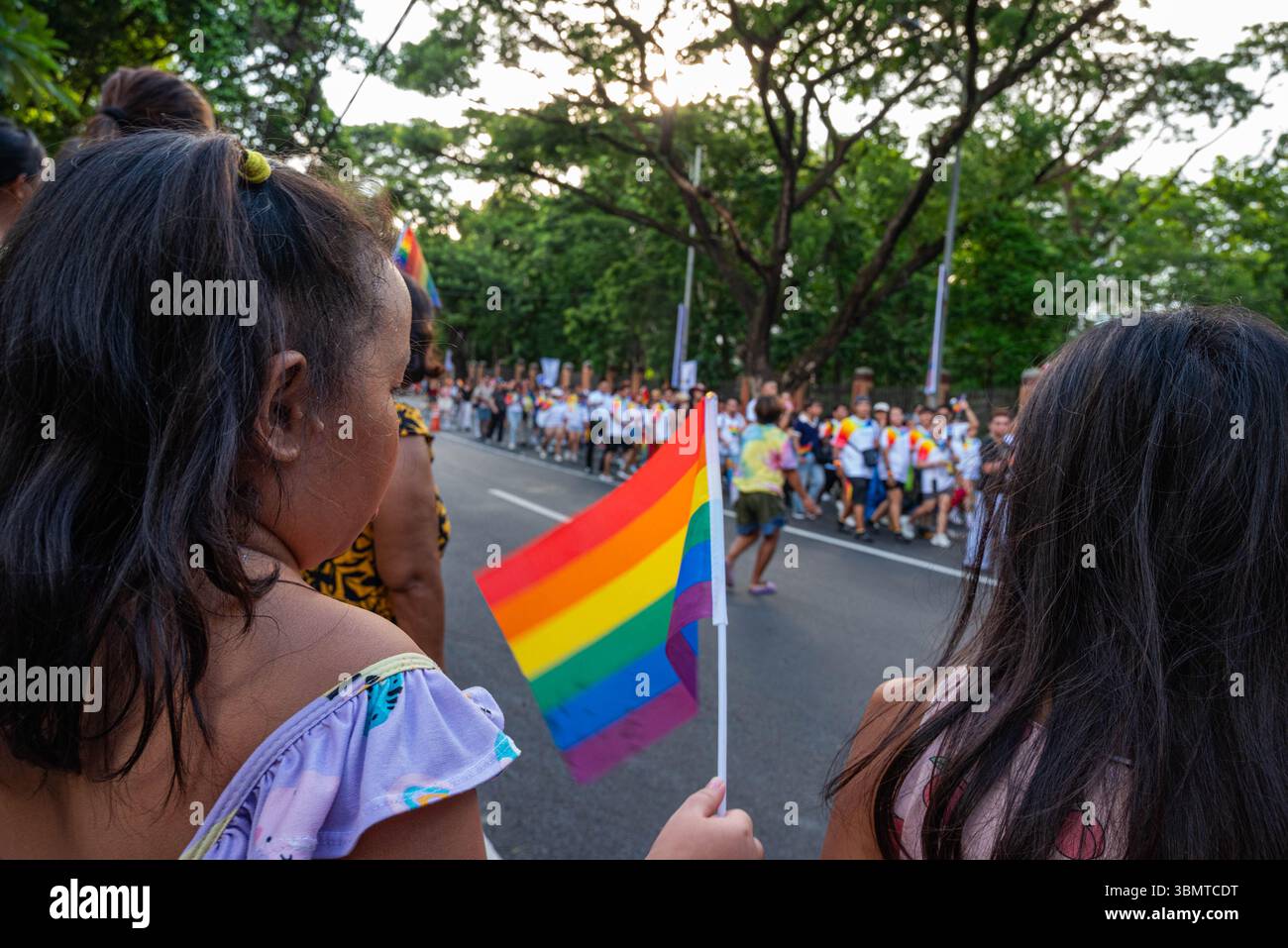 June 28, 2025, Quezon City, Quezon, Philippines: A child waves a small ...