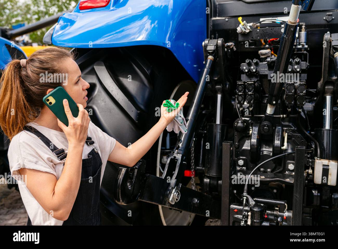 Female farmer repairing tractor hi-res stock photography and images - Alamy