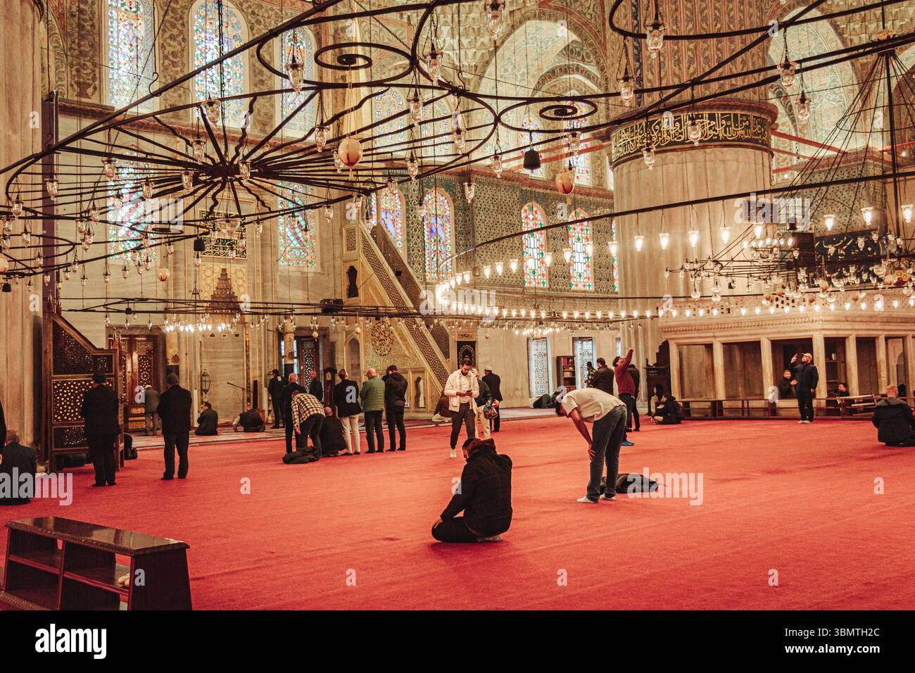 People praying inside blue mosque Stock Photo - Alamy