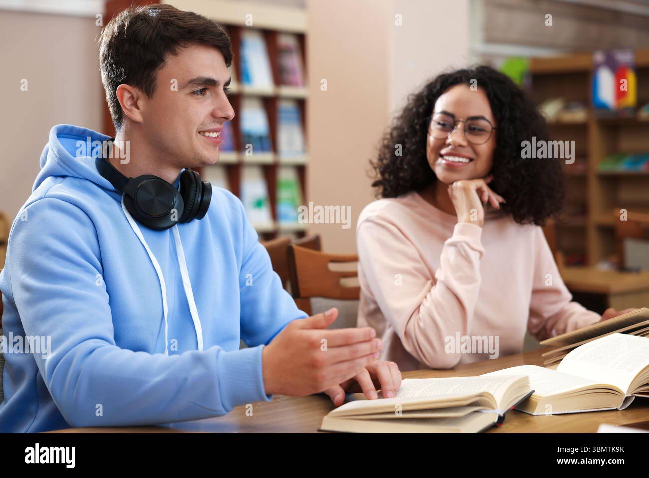 People studying together at desks in public library Stock Photo - Alamy
