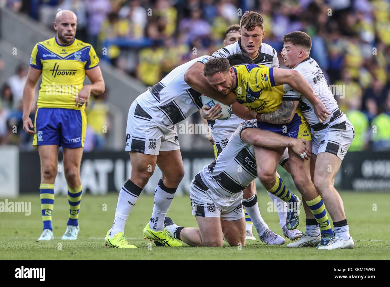 Ben Currie of Warrington Wolves is tackled during the Betfred Super League round 16 match ...