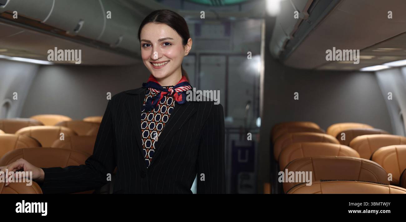 Friendly flight attendant welcomes passengers hi-res stock photography ...