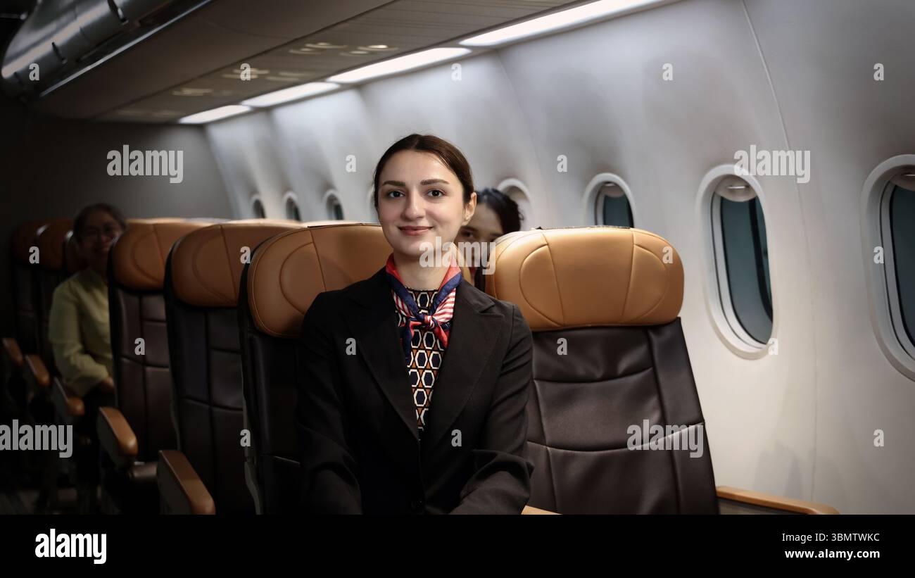 Friendly flight attendant welcomes passengers hi-res stock photography ...