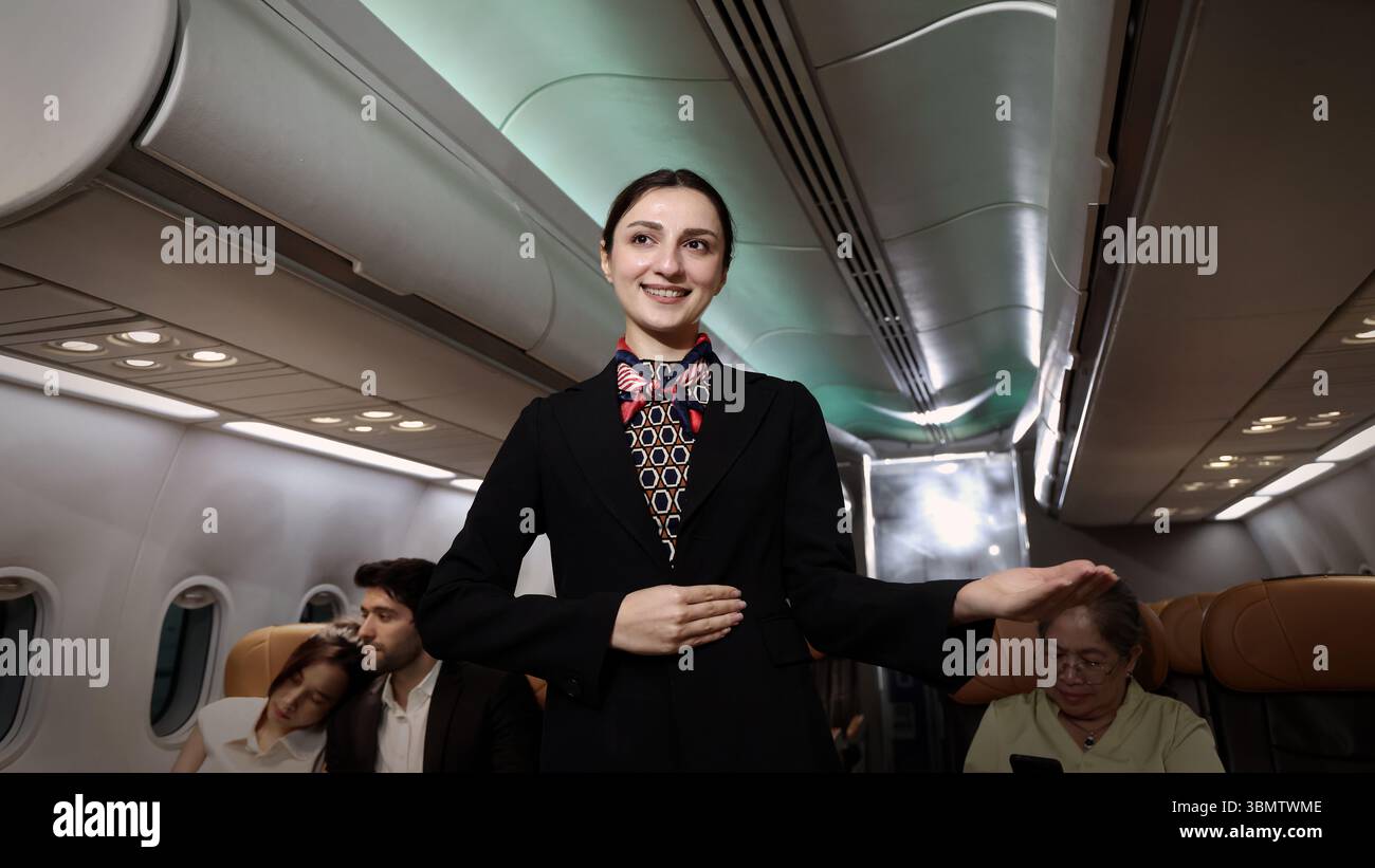 Air hostess. Smiling flight attendant in uniform welcomes and guides ...
