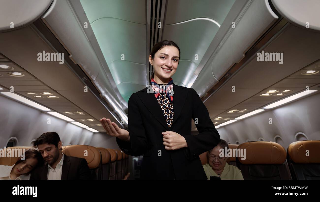 Friendly flight attendant welcomes passengers hi-res stock photography ...