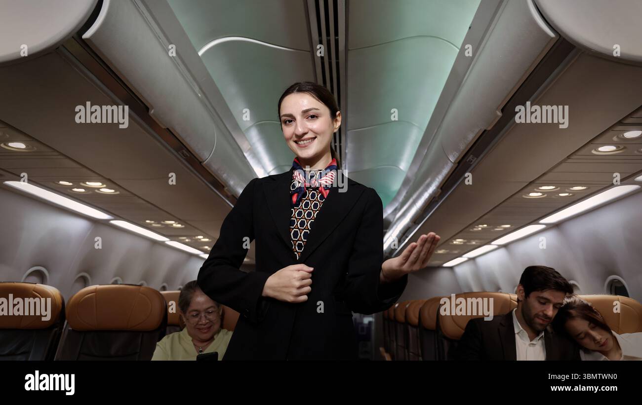 Friendly flight attendant welcomes passengers hi-res stock photography ...