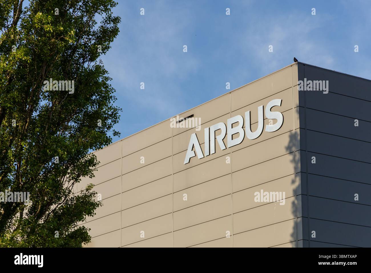 The prominent Airbus logo is displayed on the side of a modern ...