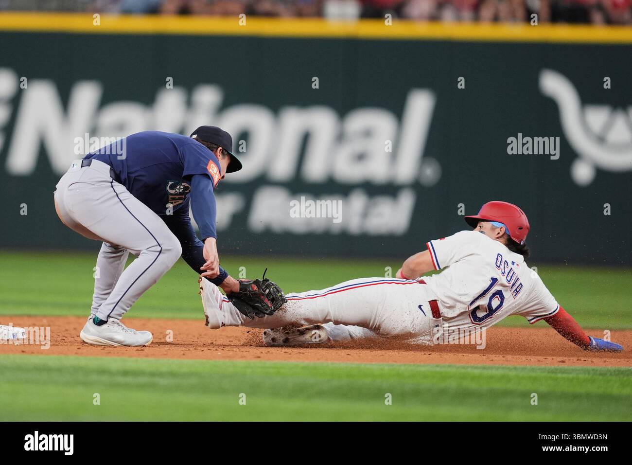 Seattle Mariners second baseman Cole Young, left, tags out Texas ...