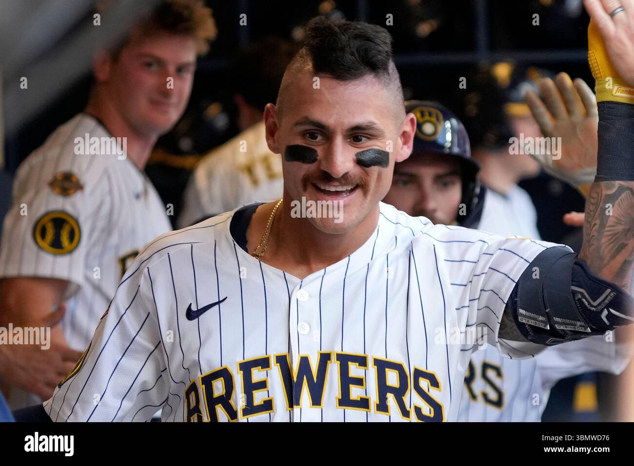 Milwaukee Brewers' Joey Ortiz high-fives teammates after hitting a two ...