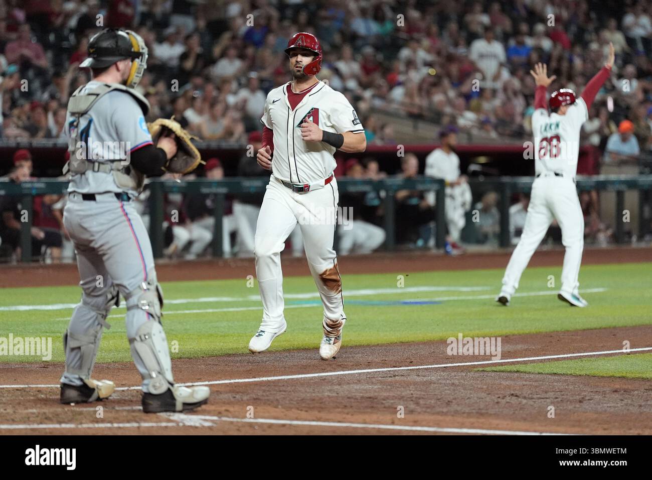 Arizona Diamondbacks' Randal Grichuk, center, scores a run as Miami ...