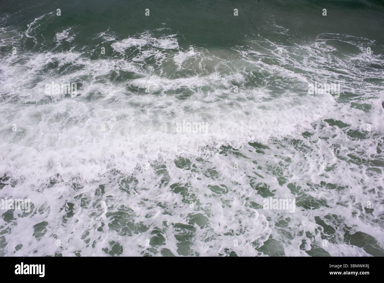 An ocean wave swirls in a circle near the shore in North Carolina Stock ...