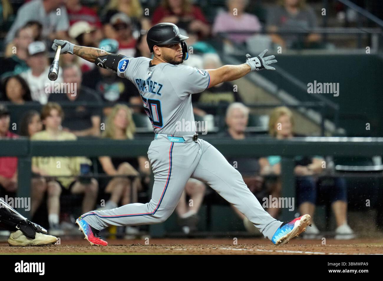 Miami Marlins' Agustín Ramírez follows through with his swing for run-scoring single against the ...