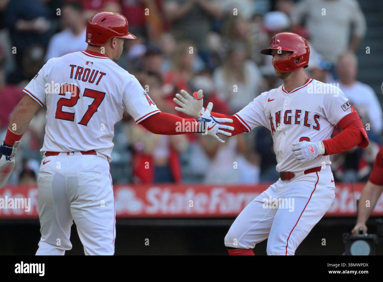 Los Angeles Angels' Mike Trout (27) greets Angels' Taylor Ward after ...