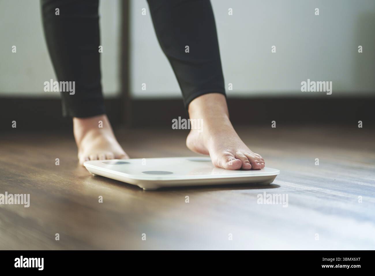 Woman feet standing on digital scales for diet control Stock Photo - Alamy