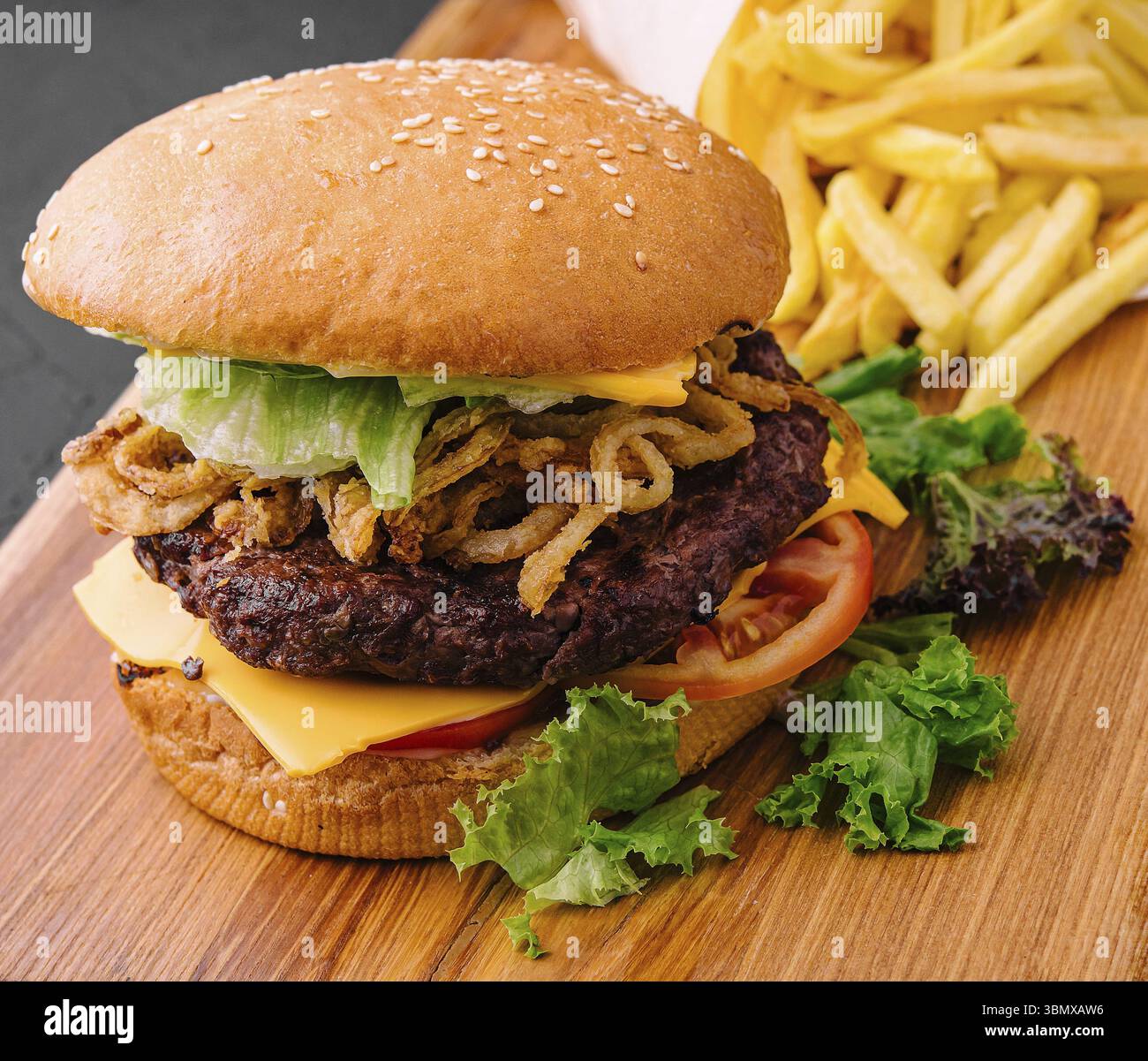 food still-life, Burger with onion chips and fries Stock Photo - Alamy