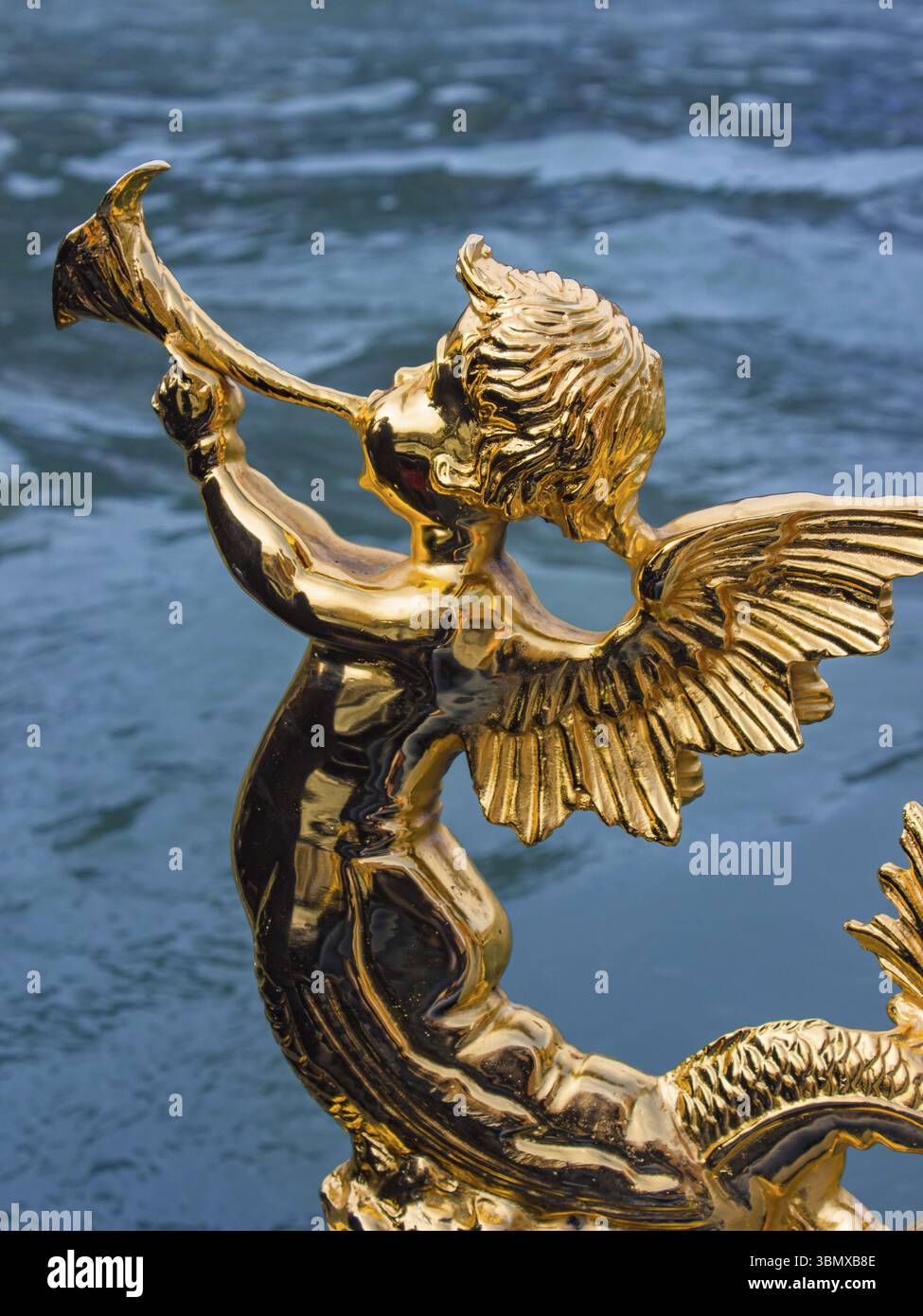 Gold figure of an angel on a gondola. Traditional symbol of Italy on ...
