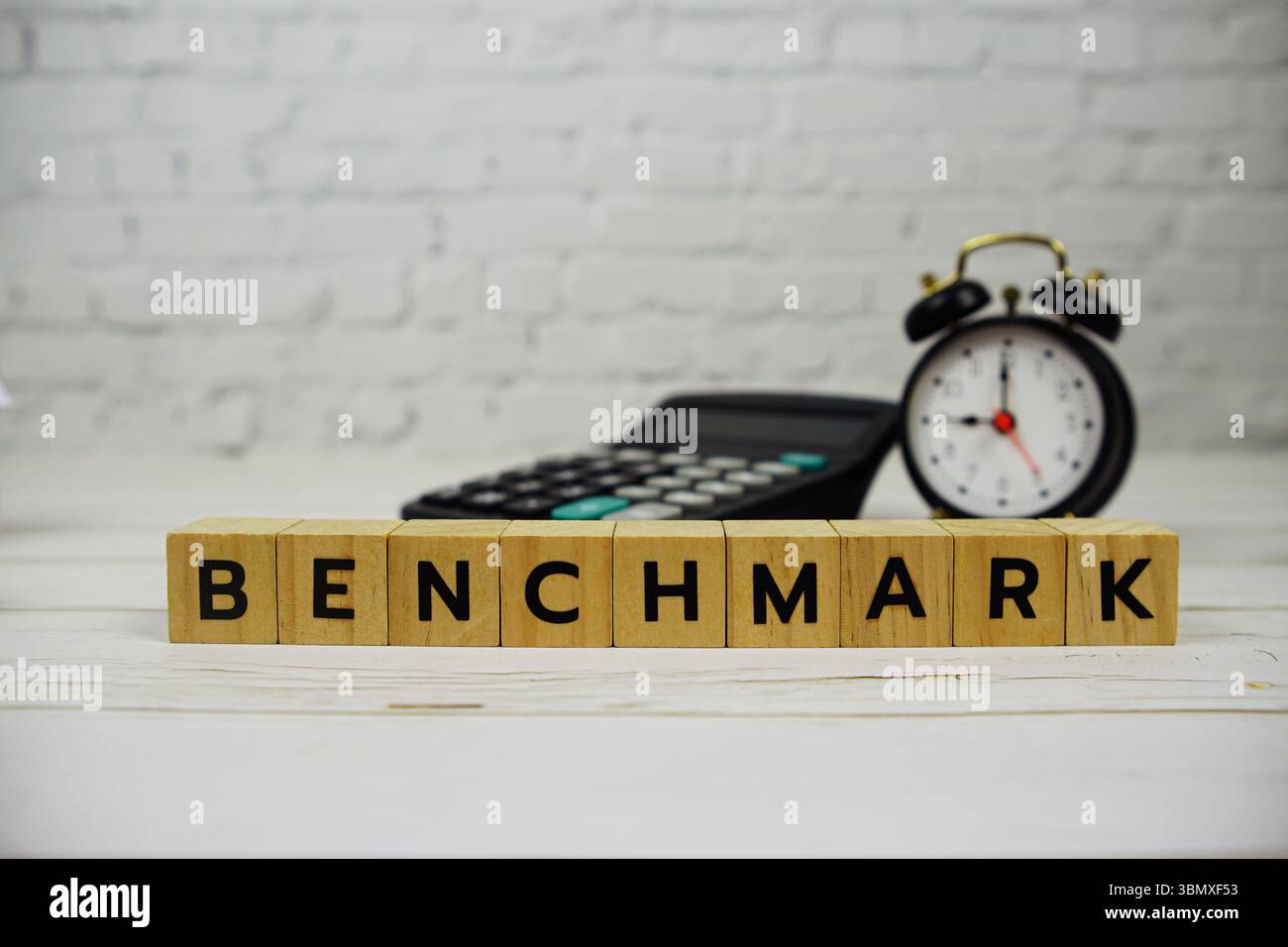 Benchmark with wooden blocks alphabet letters and calculator, alarm ...
