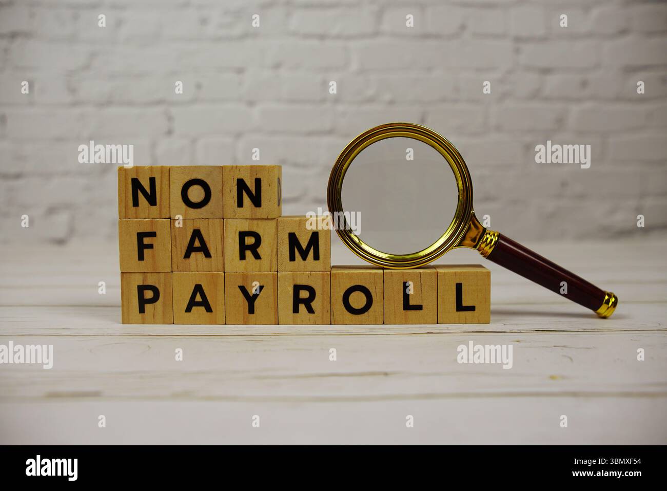 Non Farm Payroll with wooden blocks alphabet letters and magnifying ...