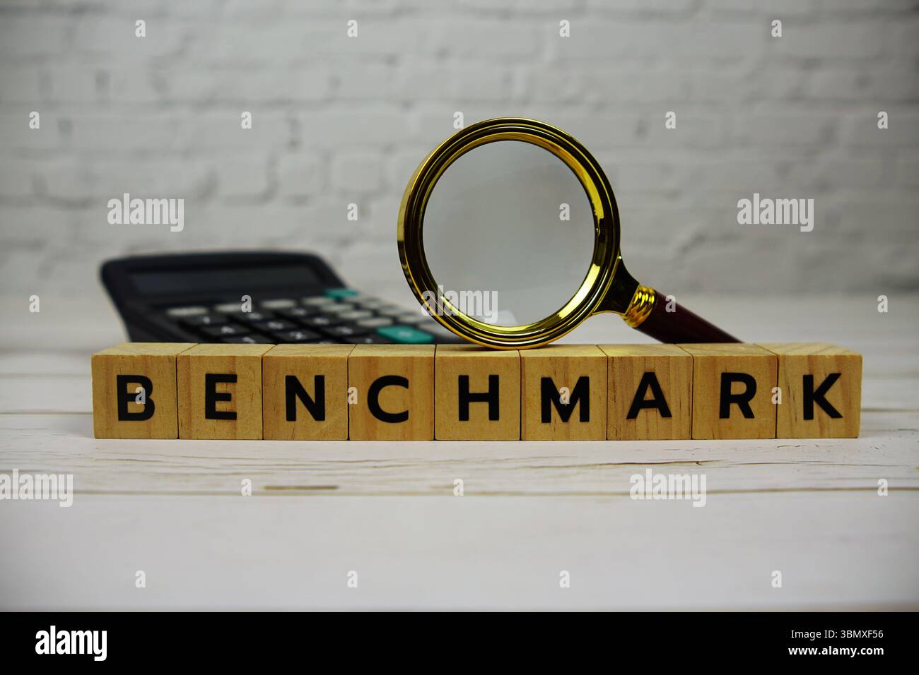 Benchmark with wooden blocks alphabet letters and magnifying glass ...
