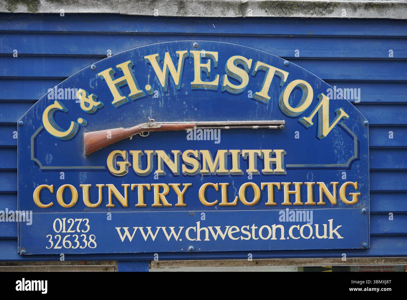 Wooden Signboard Displaying Gunsmith and Country Clothing Business ...