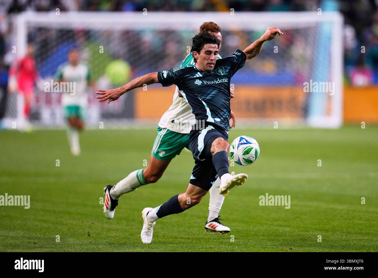 Seattle Sounders midfielder Paul Rothrock, front, reaches for the ball against Austin FC ...