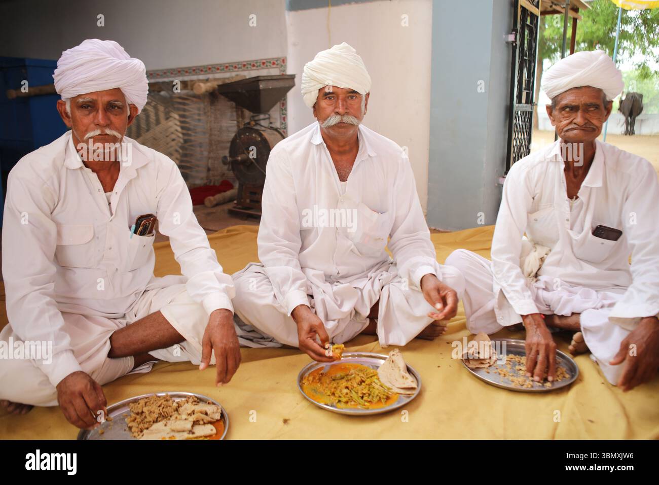 Three Rajasthani Marwadi elders enjoying traditional Indian wedding ...