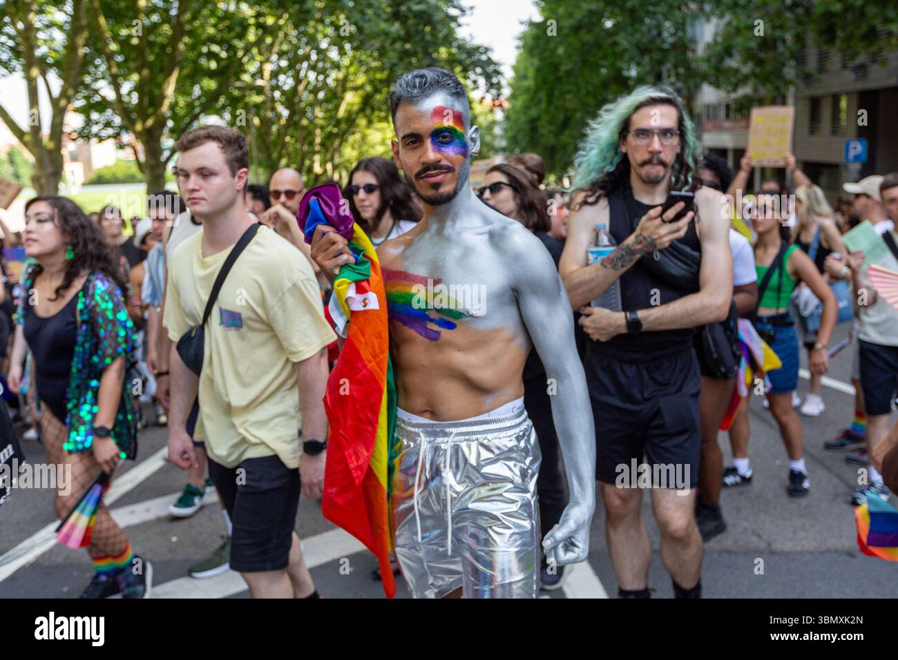 A participant painted in silver body paint with a vibrant rainbow ...