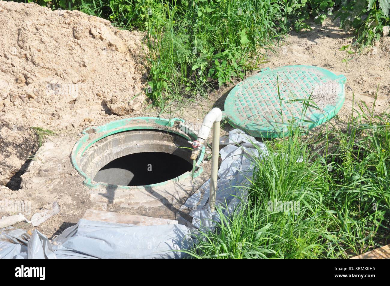 Installing water borehole drilling with plastic manhole cover. Water ...