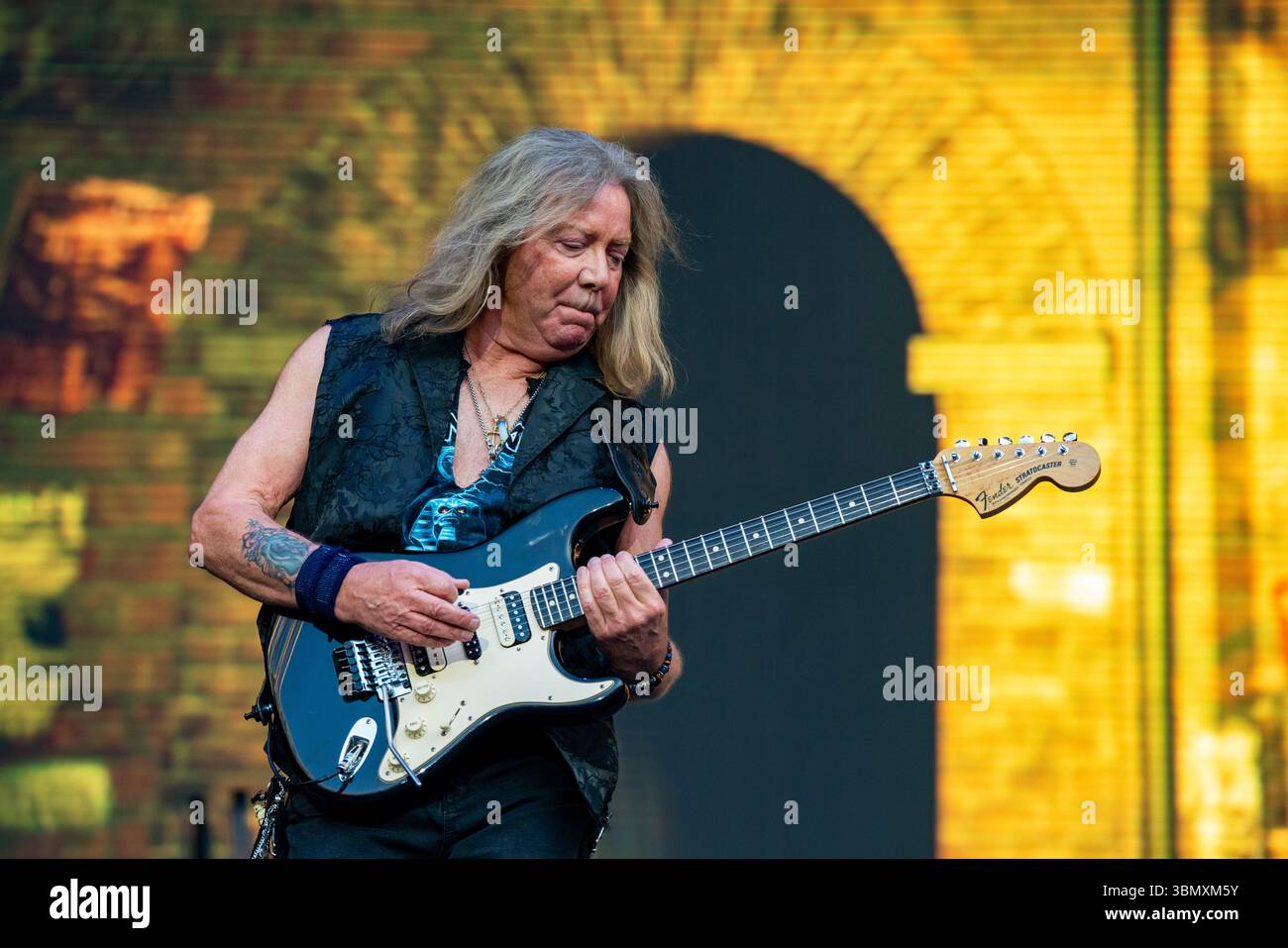 Dave Murray seen playing guitar live on stage with band Iron Maiden ...