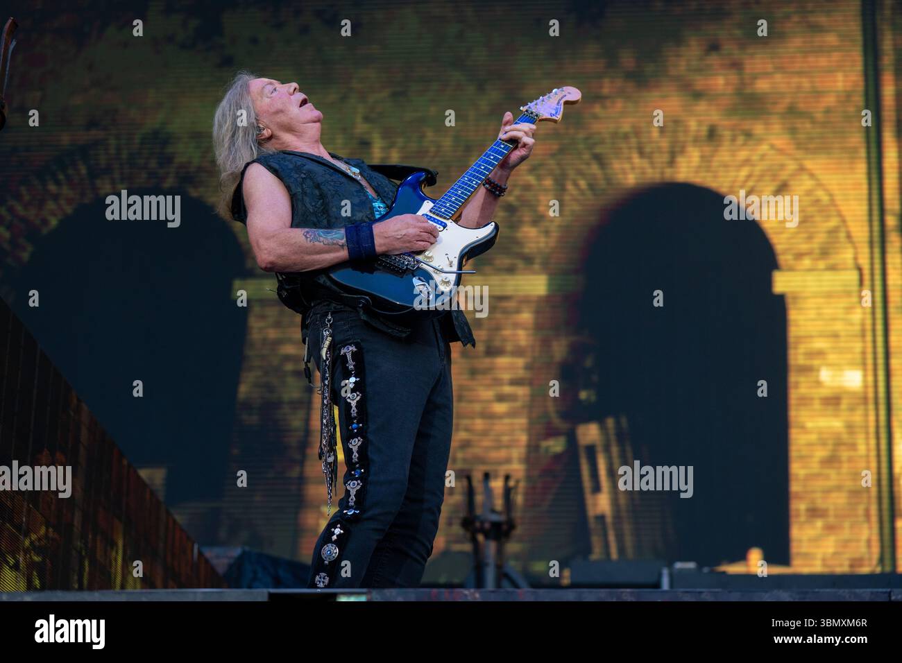 Dave Murray seen playing guitar live on stage with band Iron Maiden ...