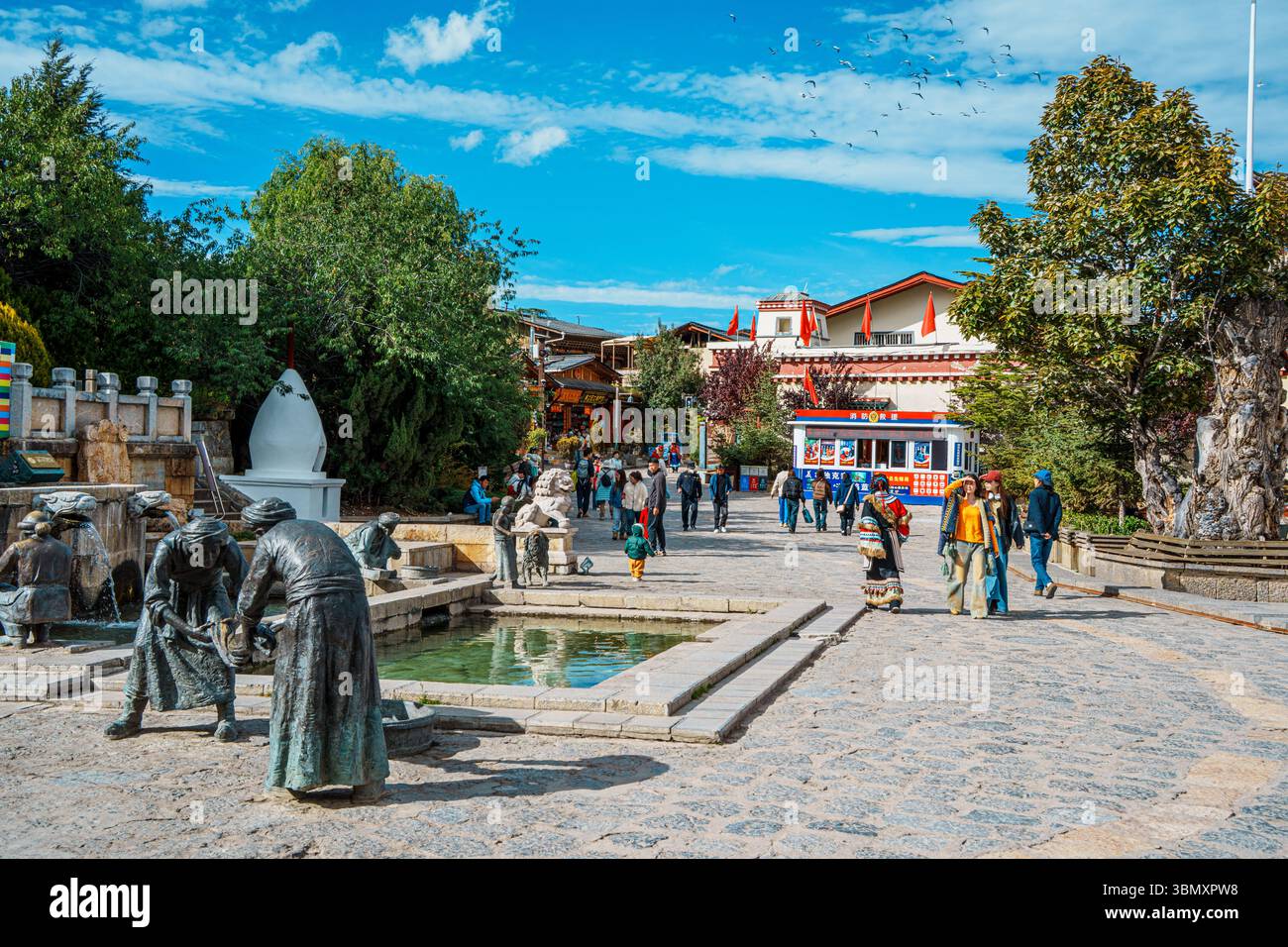 A vibrant scene in an old town square in Shangri-La, featuring bronze ...