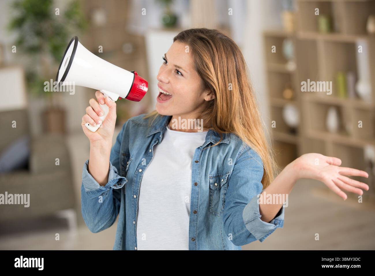 beautiful woman screaming in megaphone Stock Photo - Alamy