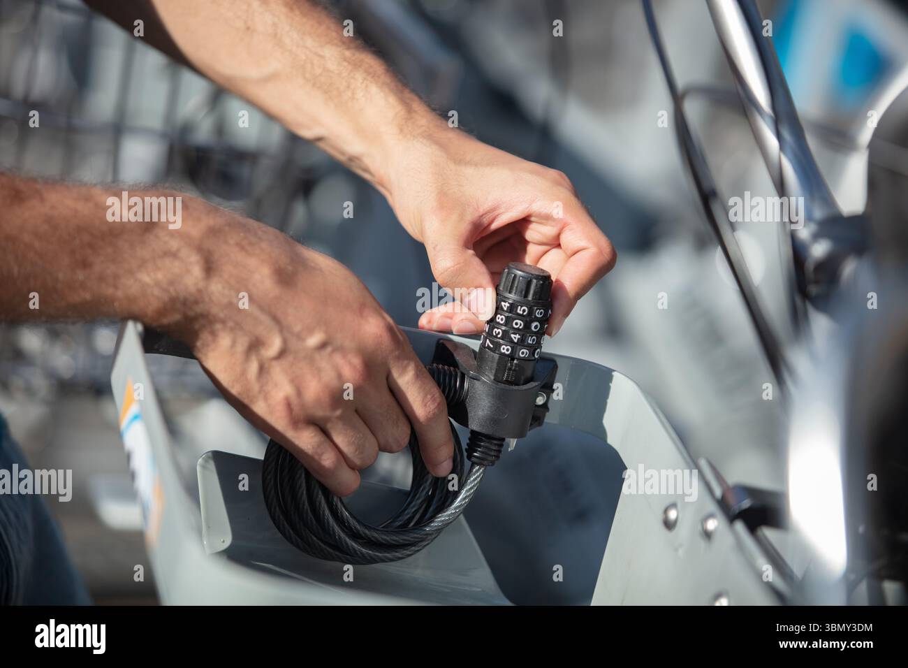 man twisting numbers on a combination lock Stock Photo - Alamy