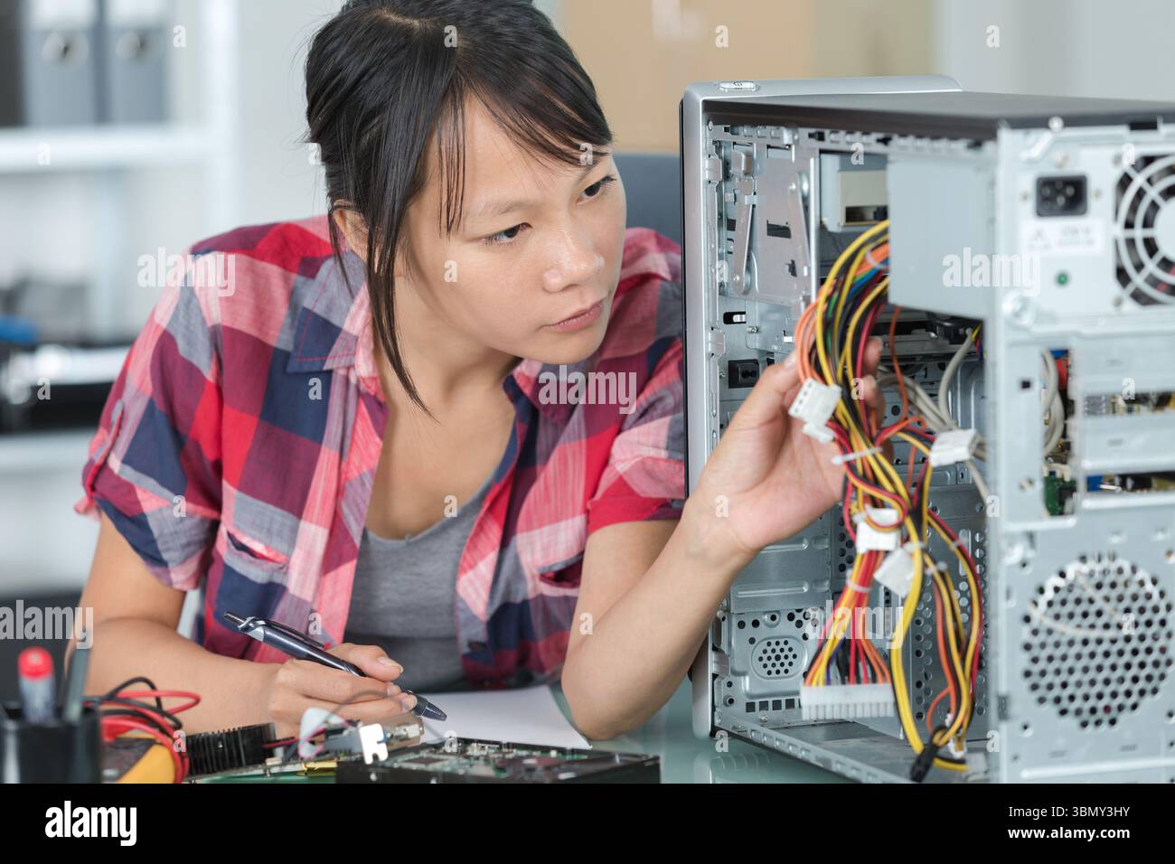 female engineer fixing a broken processor Stock Photo - Alamy