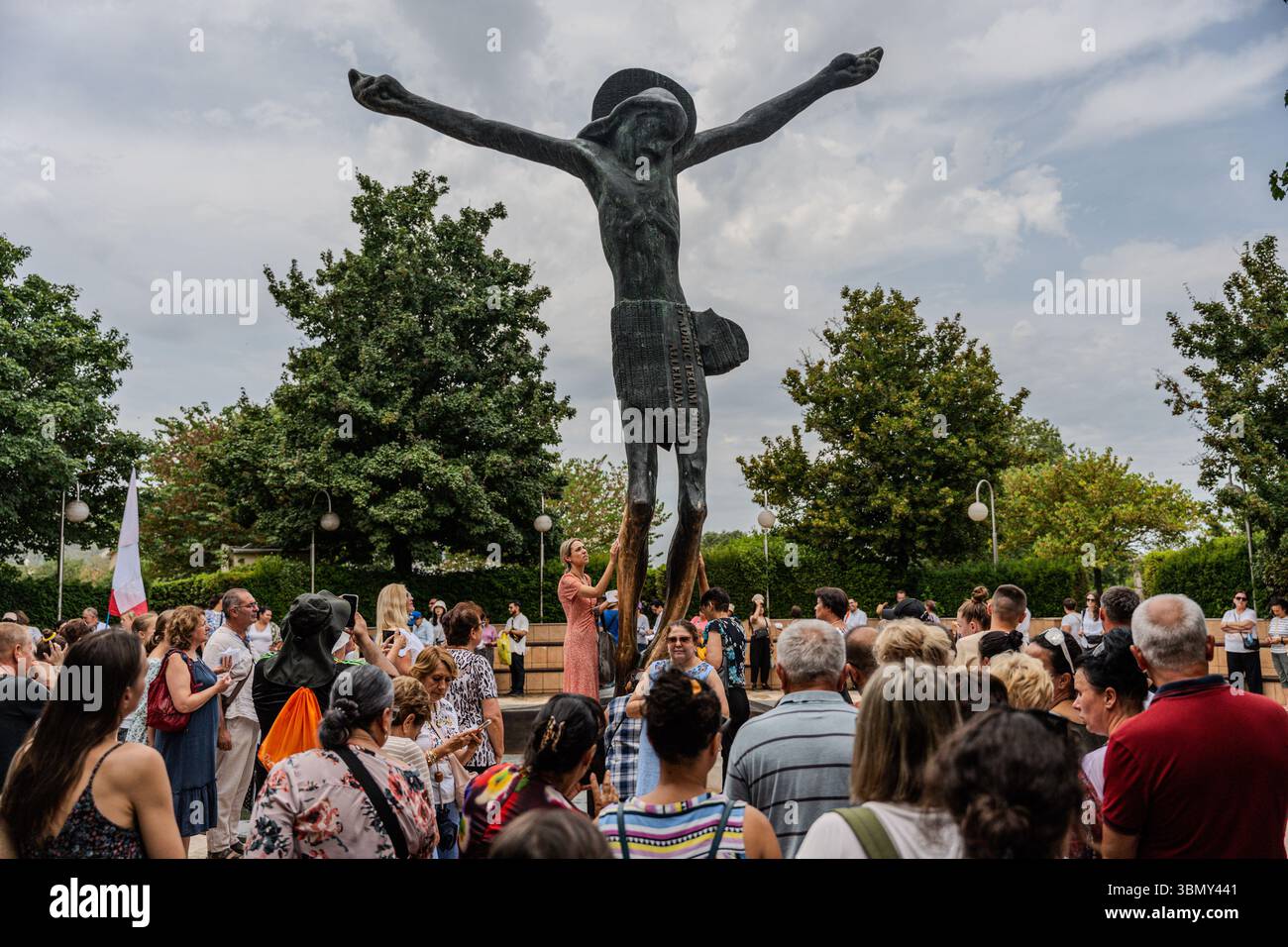 Pilgrims gathered by Risen Christ Statue in complex of Saint James ...