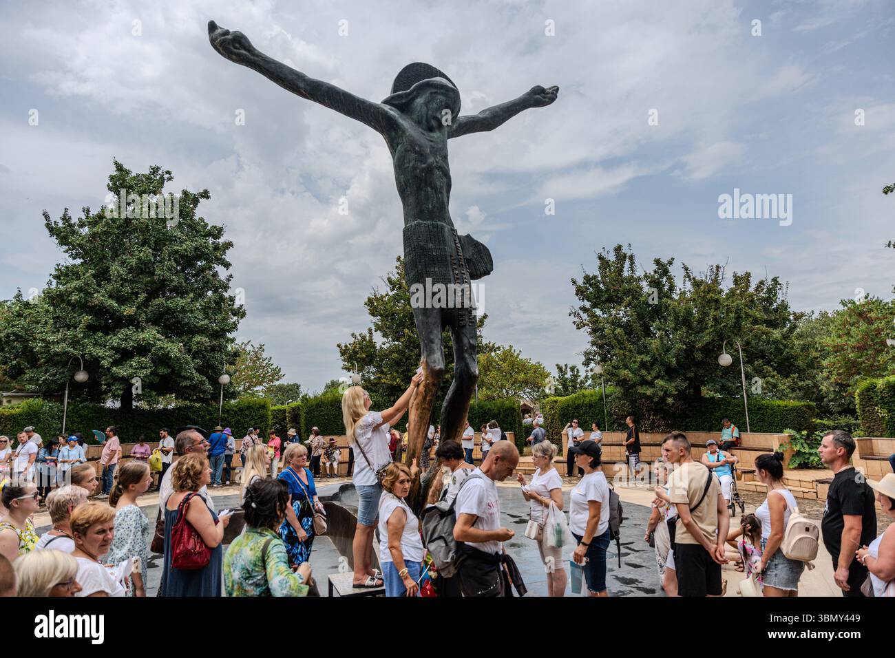 Pilgrims gathered by Risen Christ Statue in complex of Saint James ...