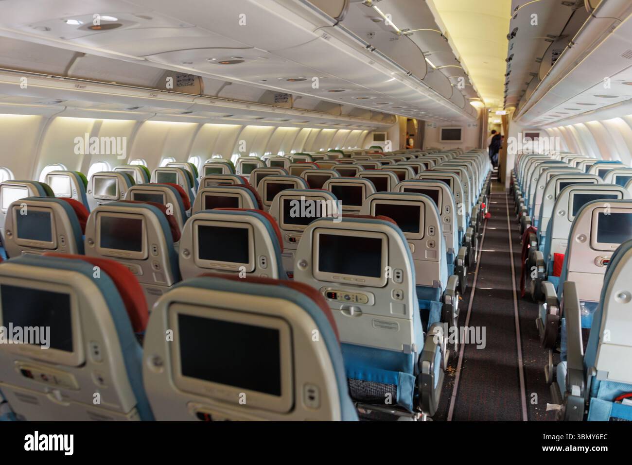 Rows of empty seats are visible within the airplane cabin, highlighting ...