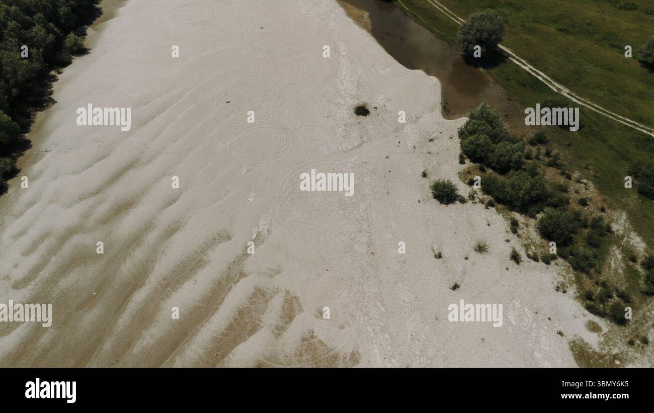 Aerial view of a wide sandy beach and nearby greenery on the Danube ...