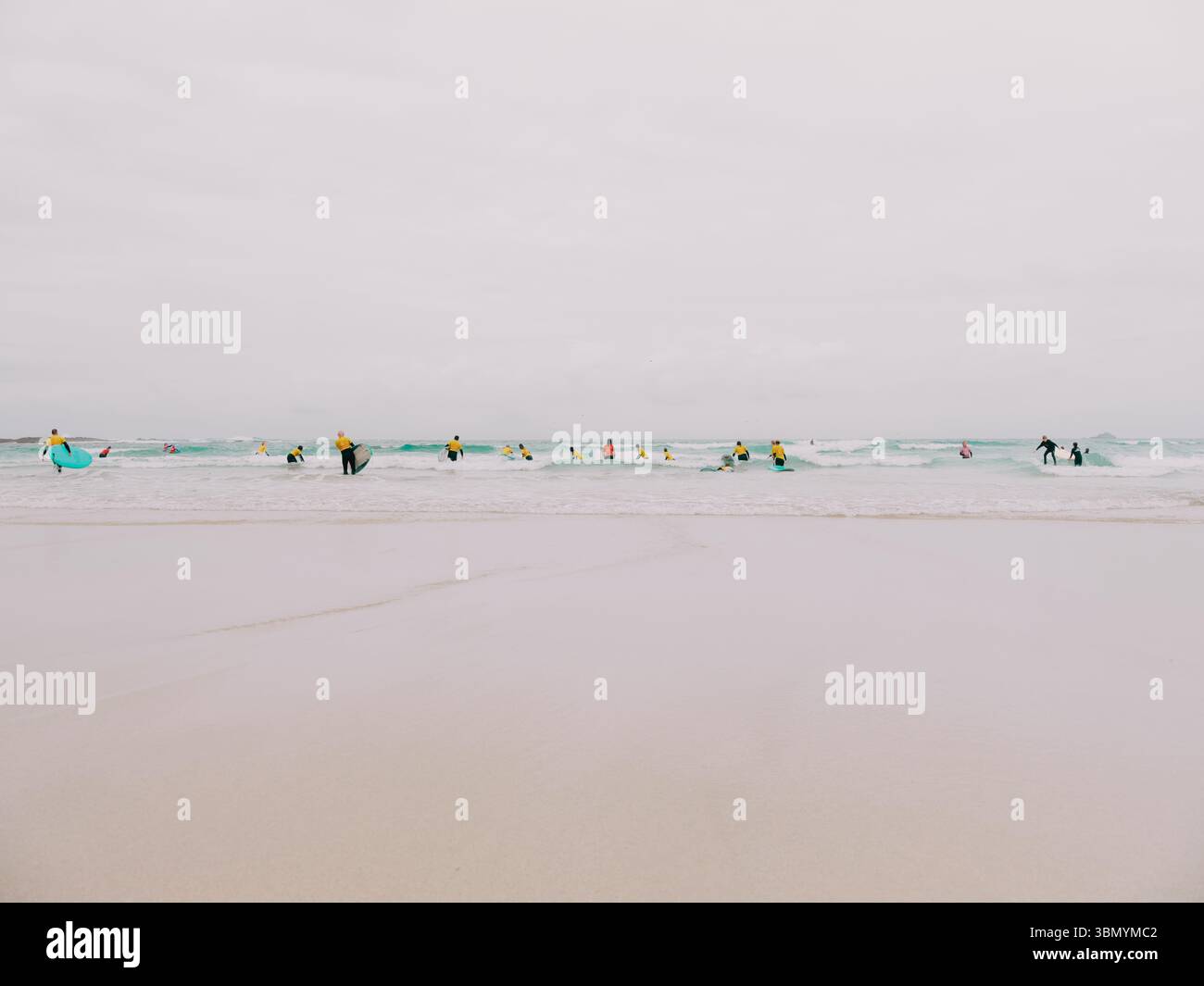 Tourists learning to surf at Surf School, Sennen Cove, Cornwall England ...