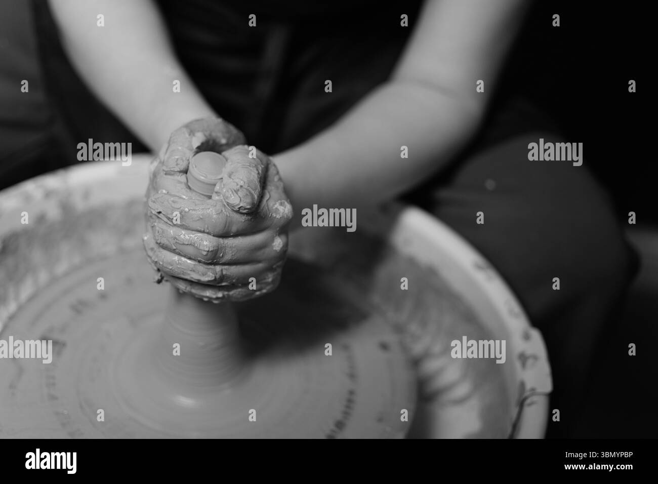 Potter shaping a ceramic artwork on a wheel. Hands in clay. Artistic ...