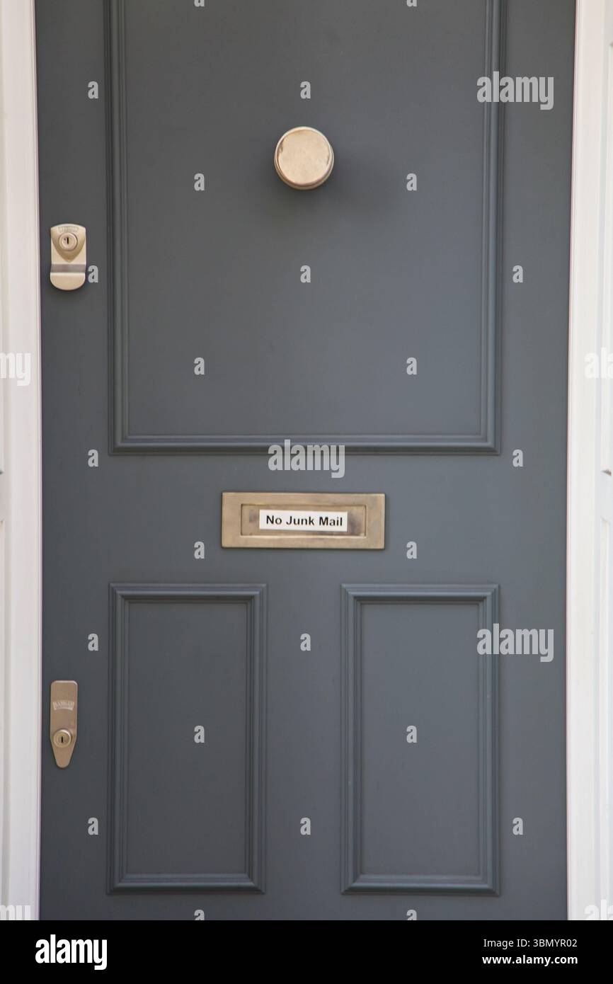 Classic British door with a mail slot sign reading "No junk mail" — a ...