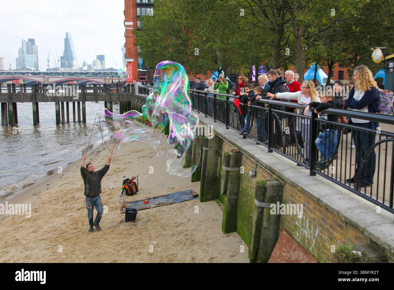 Street performer makes giant bubbles on the South Bank shore as ...