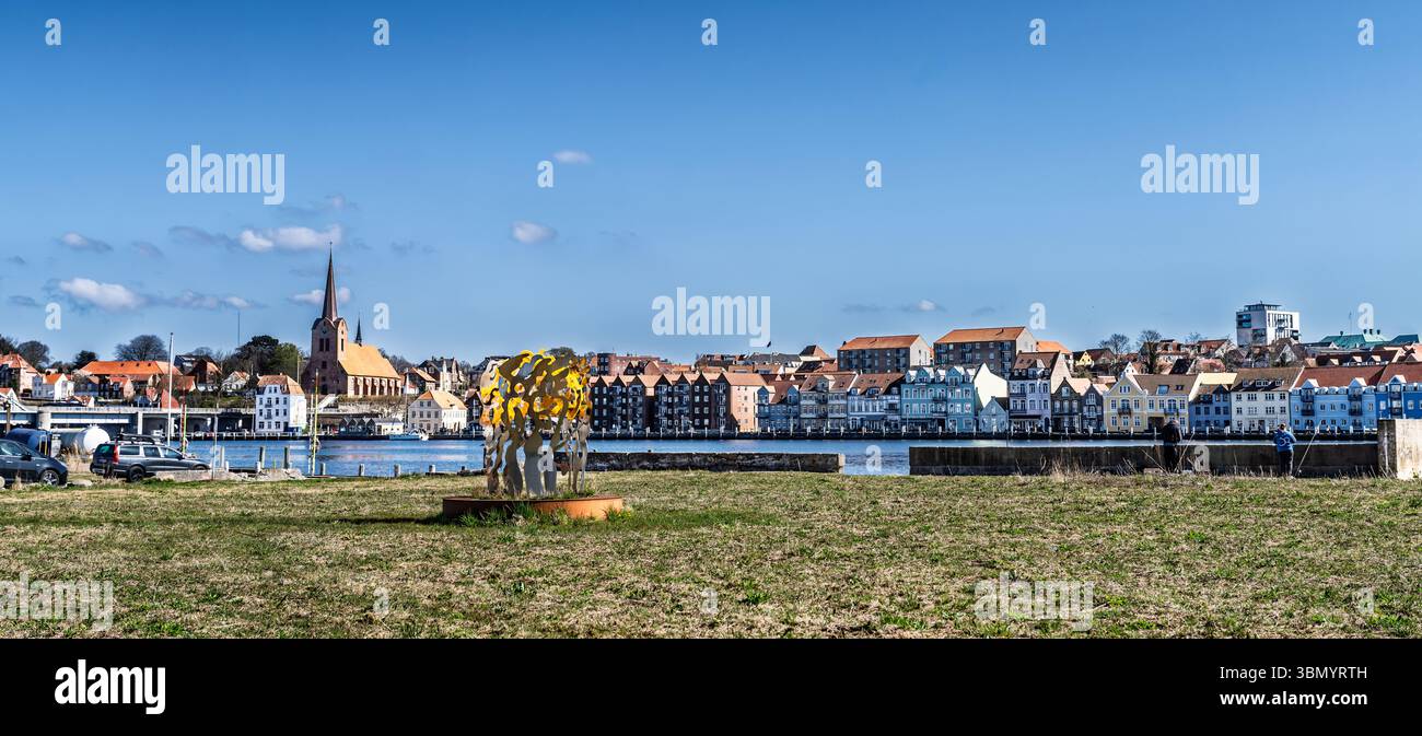 A charming waterfront town featuring colorful buildings, striking ...