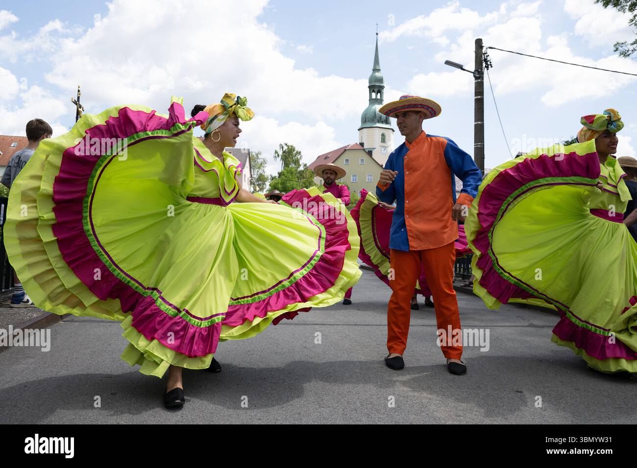 29 June 2025, Saxony, Crostwitz: A Colombian dance group takes part in ...