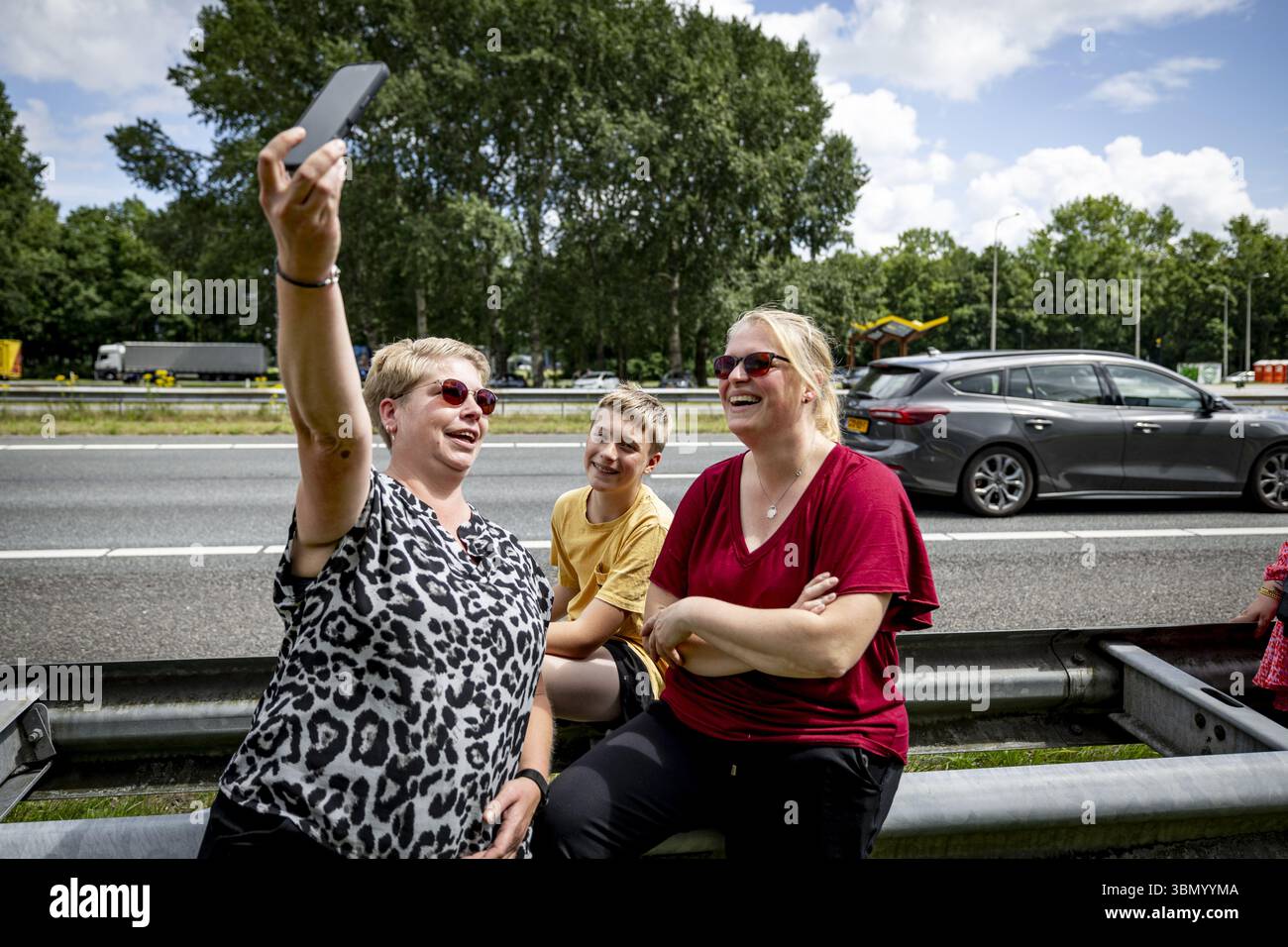 ASSEN - Race fans wave off motorcycles at De Mussels gas station along ...