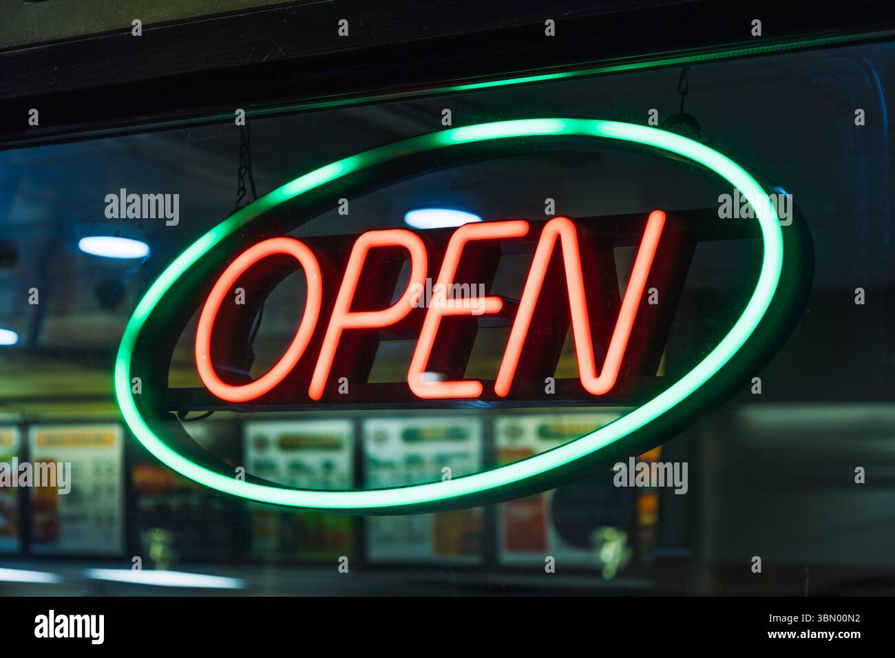 Bright Neon OPEN Sign with Green Oval Border Illuminated at Night on ...