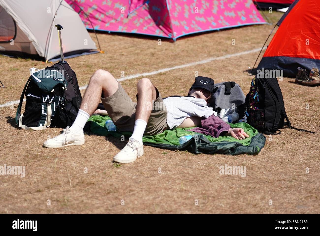 A spectator in the overnight queue ahead of the Wimbledon Championships ...