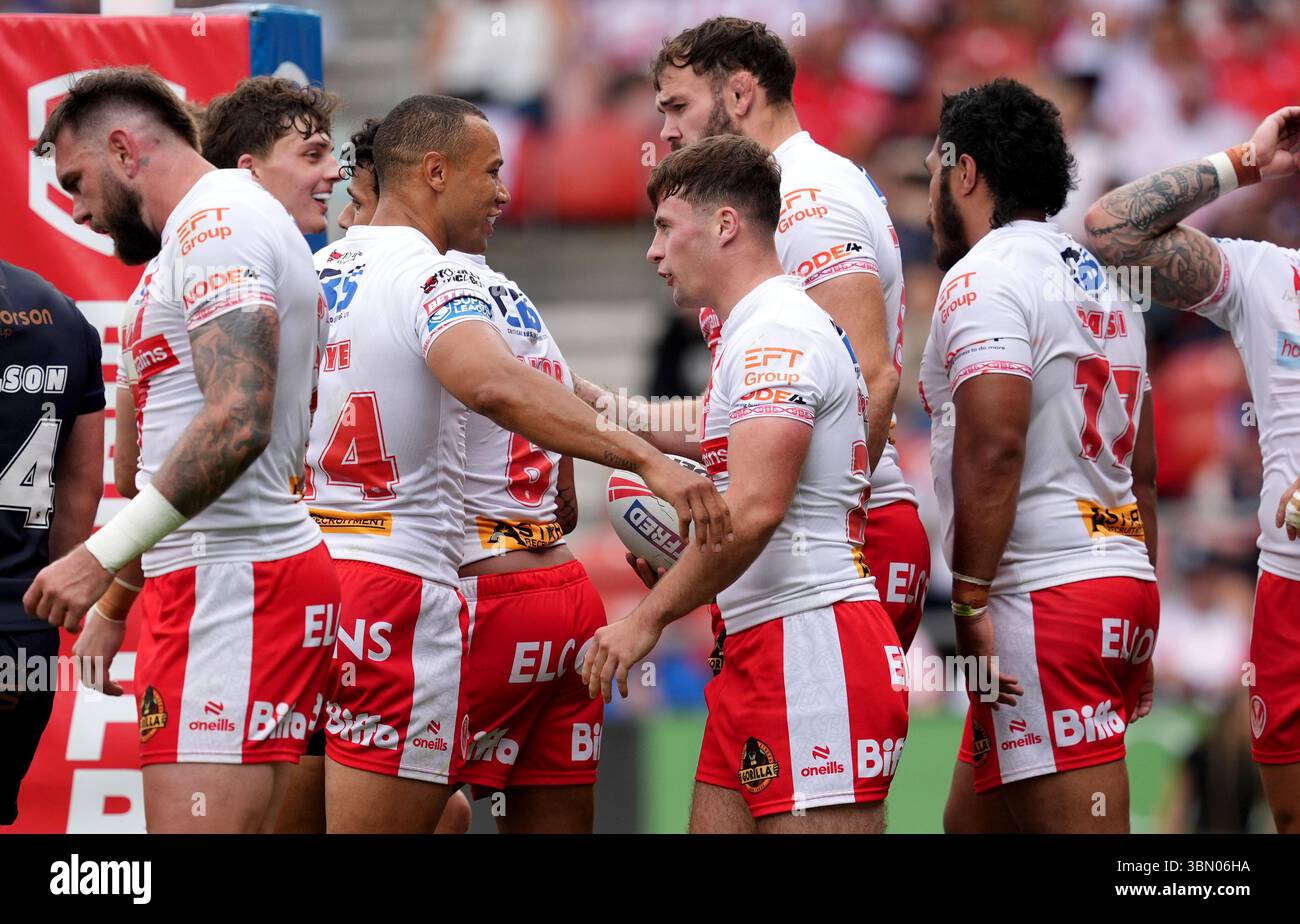 St Helen's Jake Burns (centre) celebrates with team-mates after scoring ...