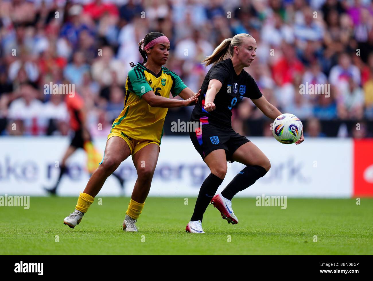 Jamaica's Amelia Van Zanten and England's Beth Mead (right) battle for ...