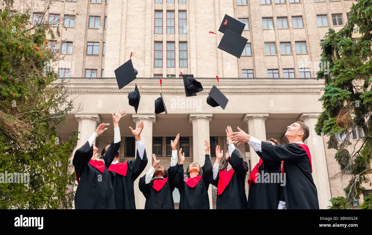 International group of students throwing graduation caps up Stock Photo ...